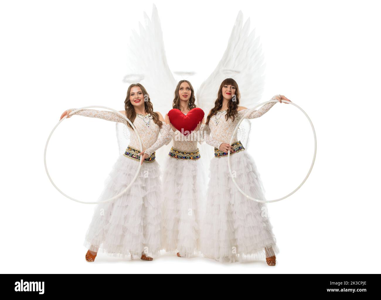 Women in angel costumes with hoops and heart Stock Photo - Alamy
