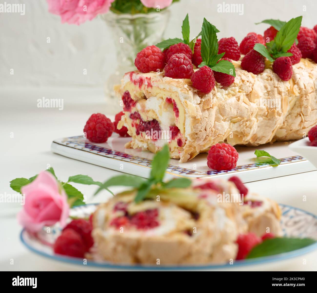 Baked meringue roll with cream and fresh red raspberry, white ...