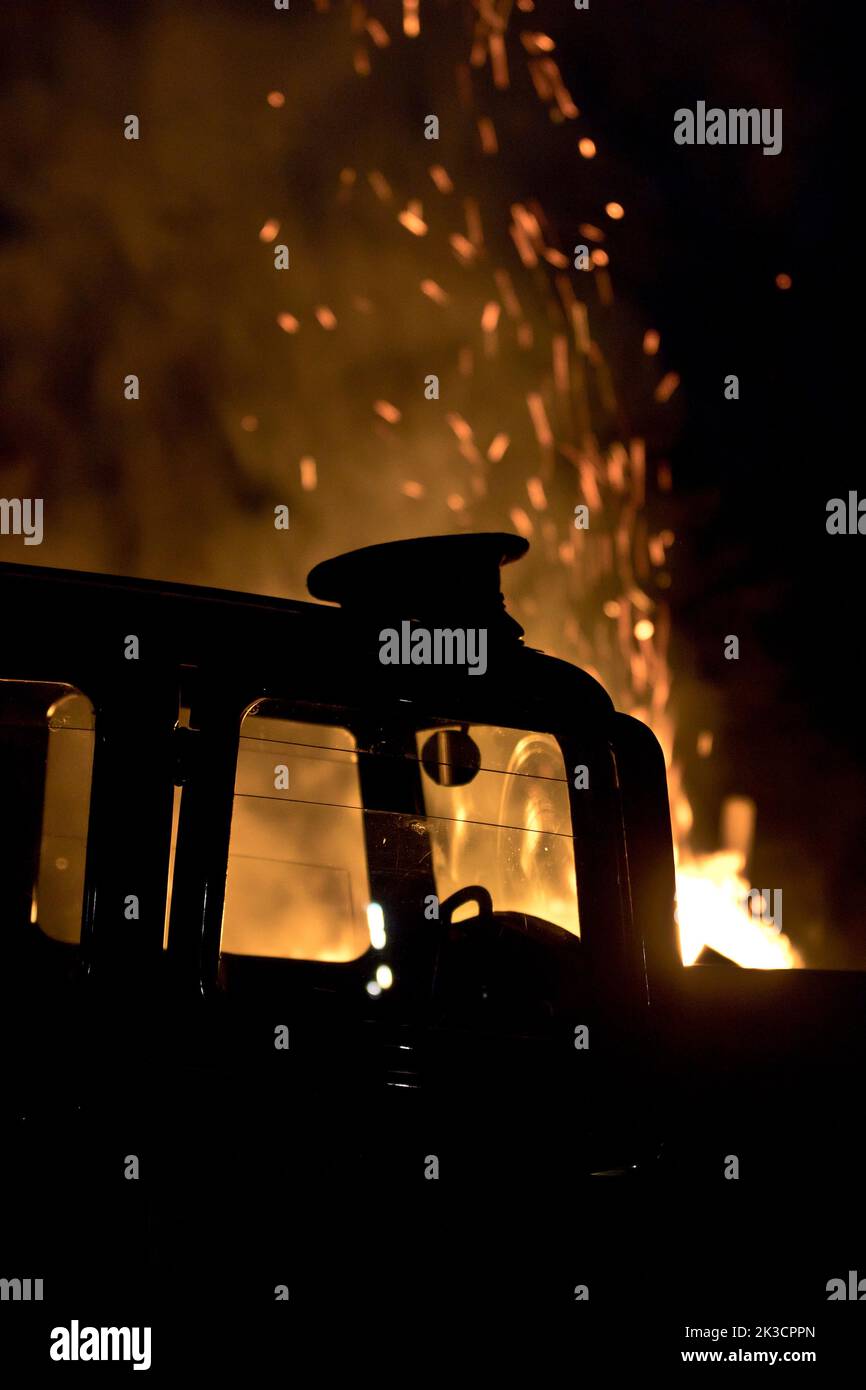 A military officer's cap laid on the roof of a 1934 Standard Ten, amid ...