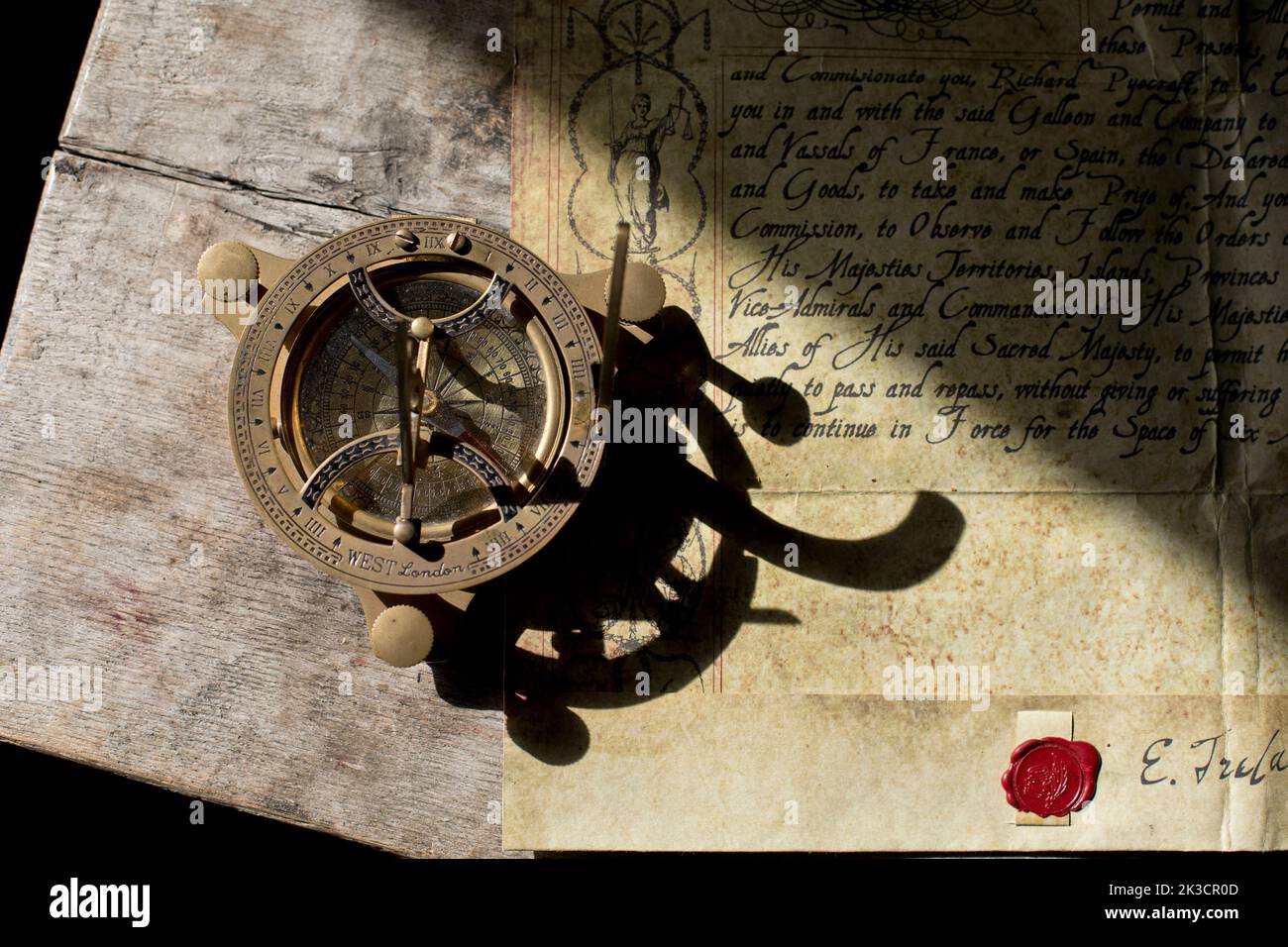 17th Century sudial compass resting on a Royal declaration to a ship's ...