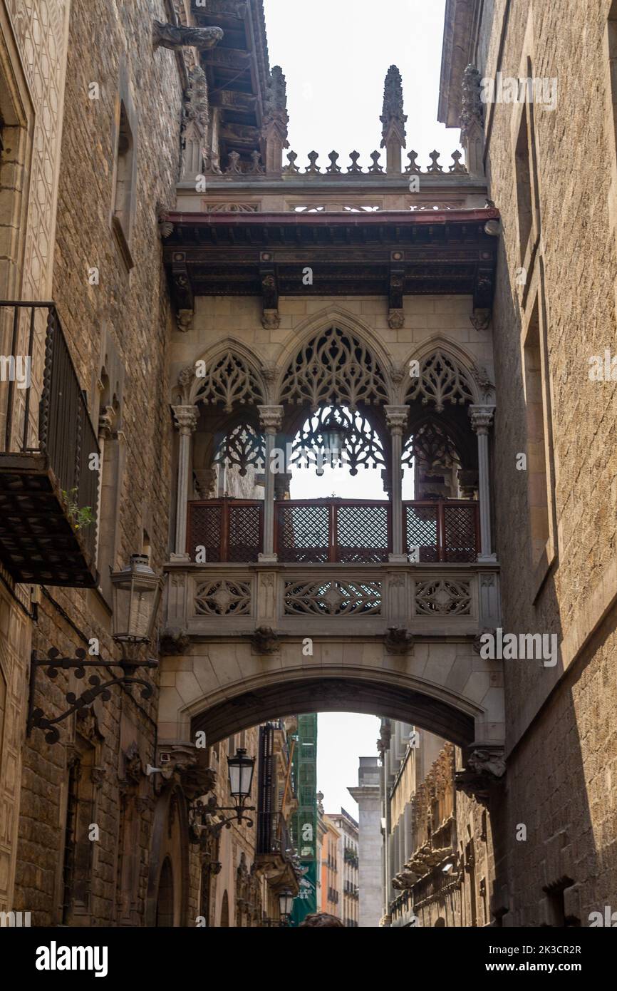 An adorned bridge connecting historical buildings in old Barcelona ...