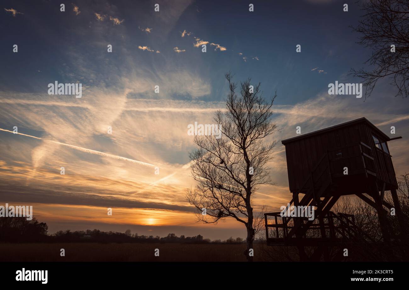 A landscape shot of a raised hut in the countryside under the cloudy ...