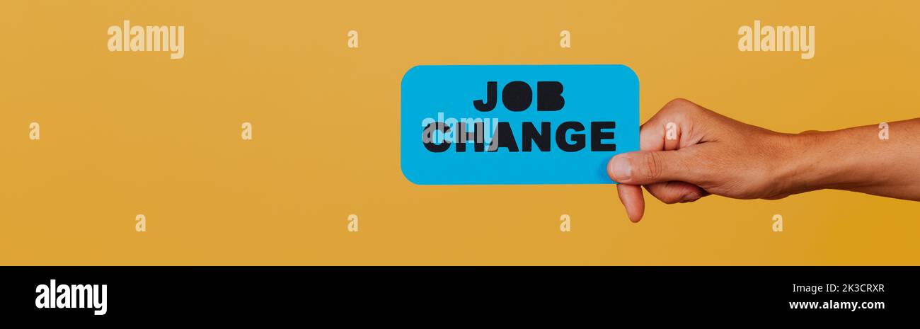 a man holds a blue signboard with the text job change in it, on a ...