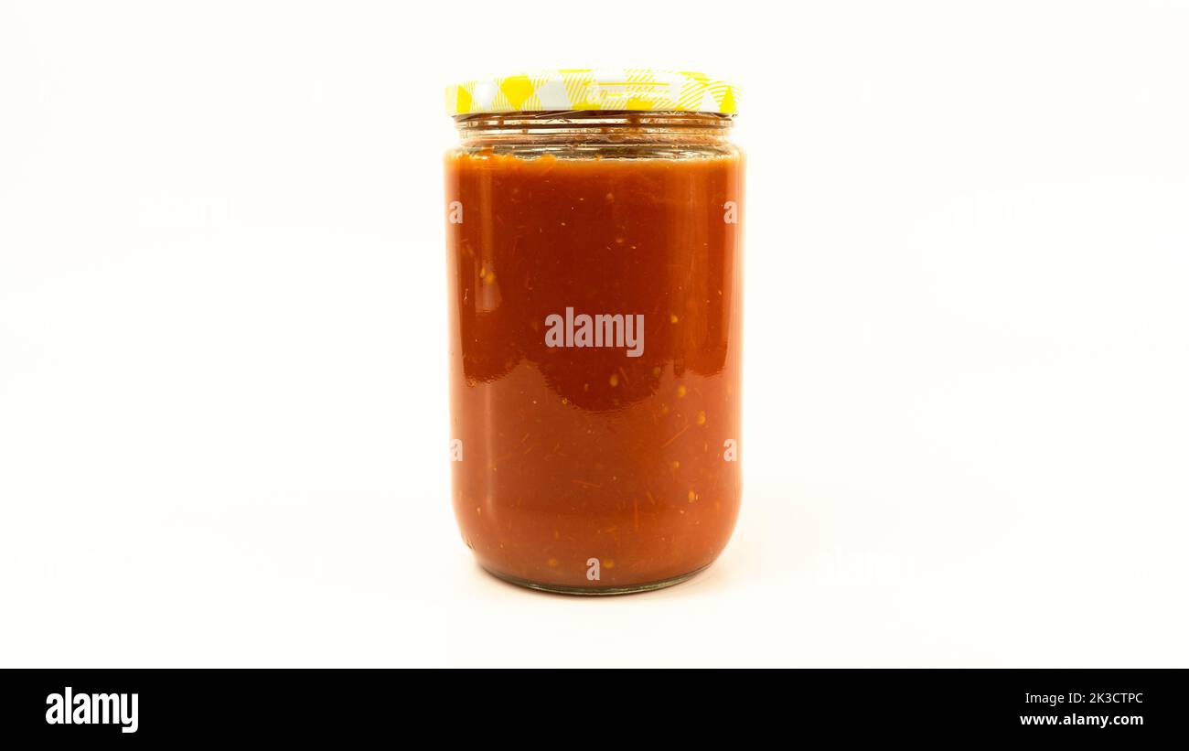 Tomato sauce in a jar. Homemade tomato sauce making process concept ...