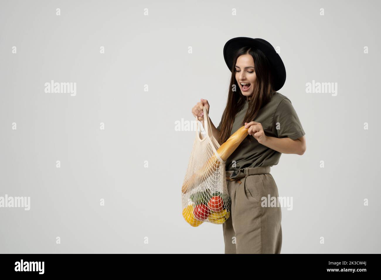 Zero waste concept. A young girl holds on her shoulder a textile mesh ...