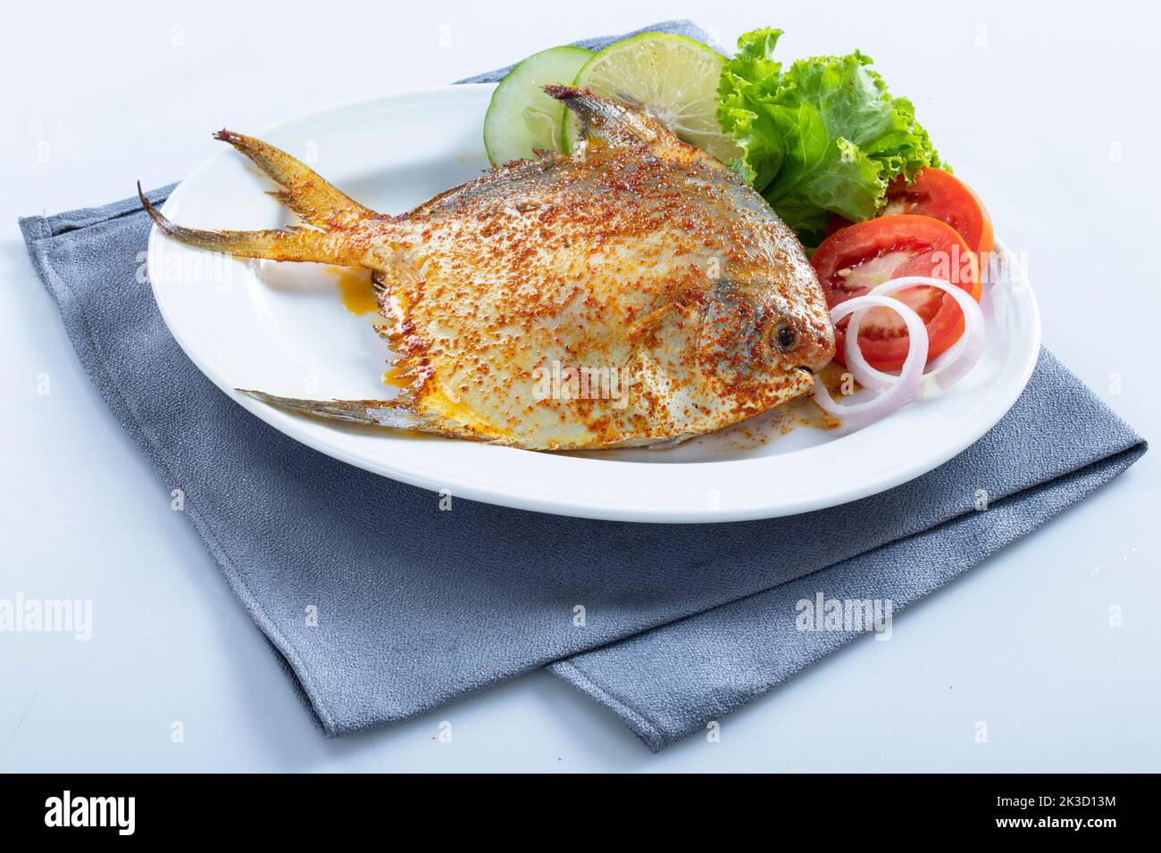 Pomfret fry on white Stock Photo - Alamy