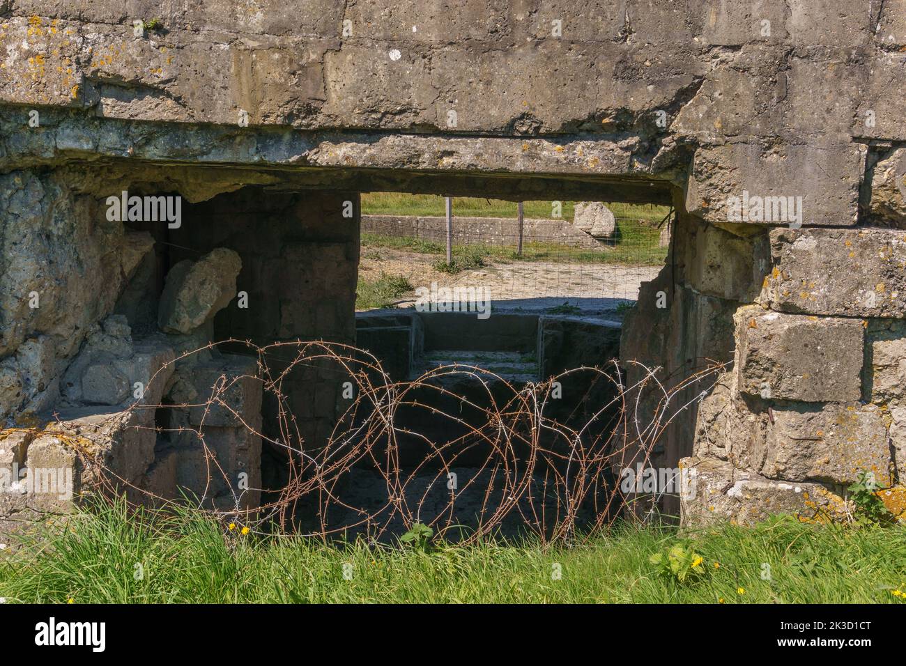 Detail of German World War 2 artillery concrete bunker with barbed wire ...