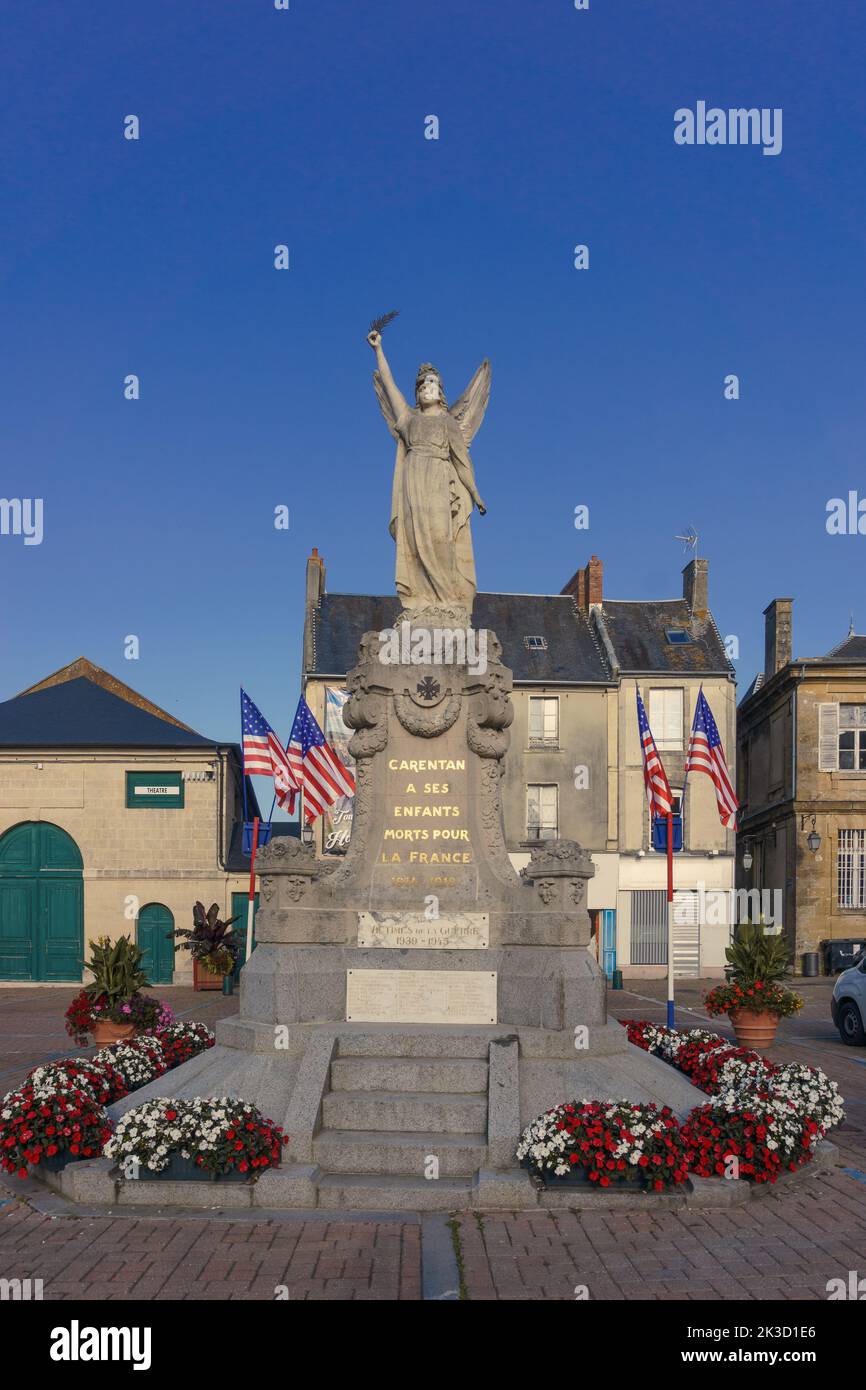 World war 1 and 2 memorial with flowers in small town of Carentan ...