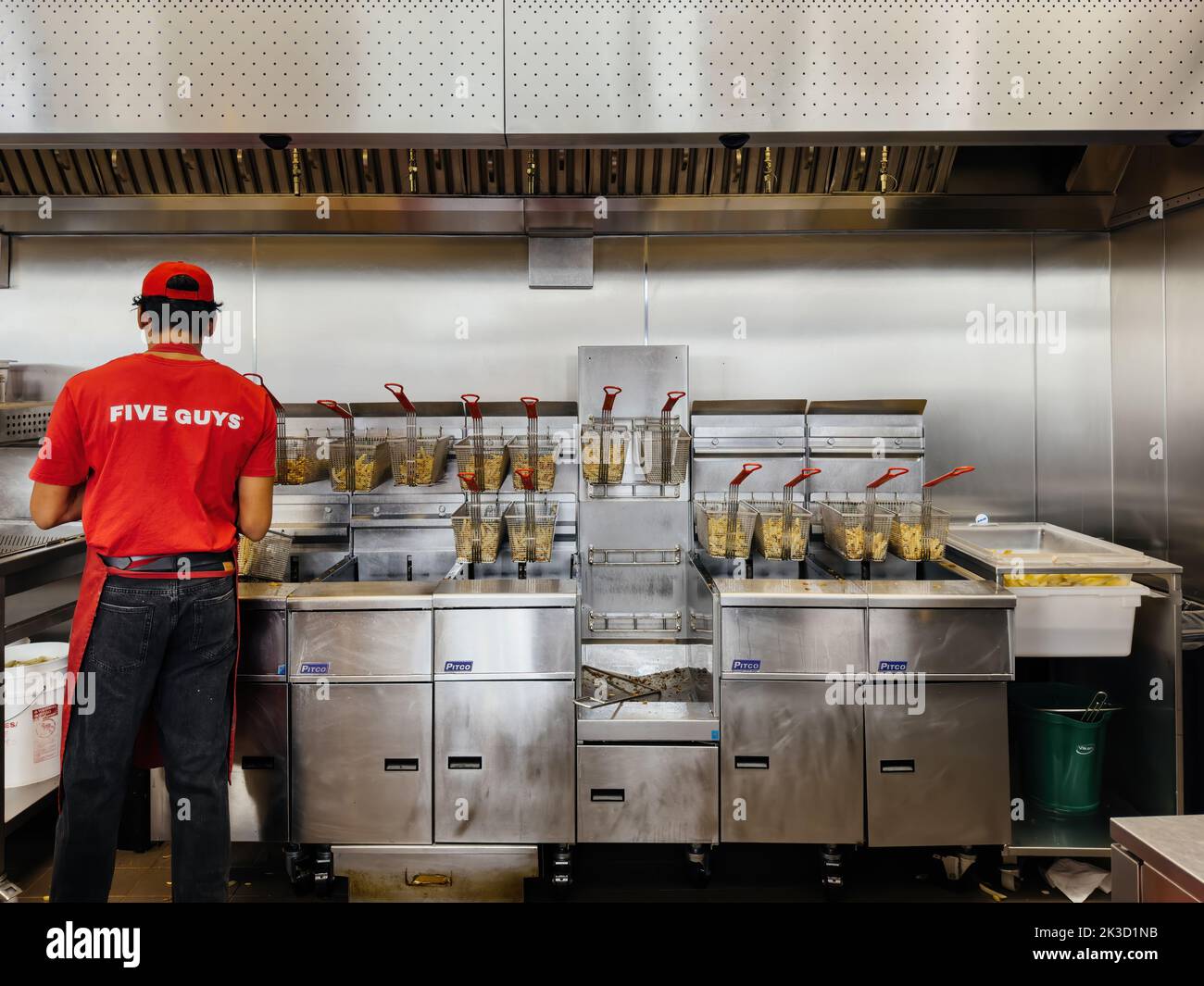 Paris, France - Sep 21, 2022: Worker at the french fries cooking in ...
