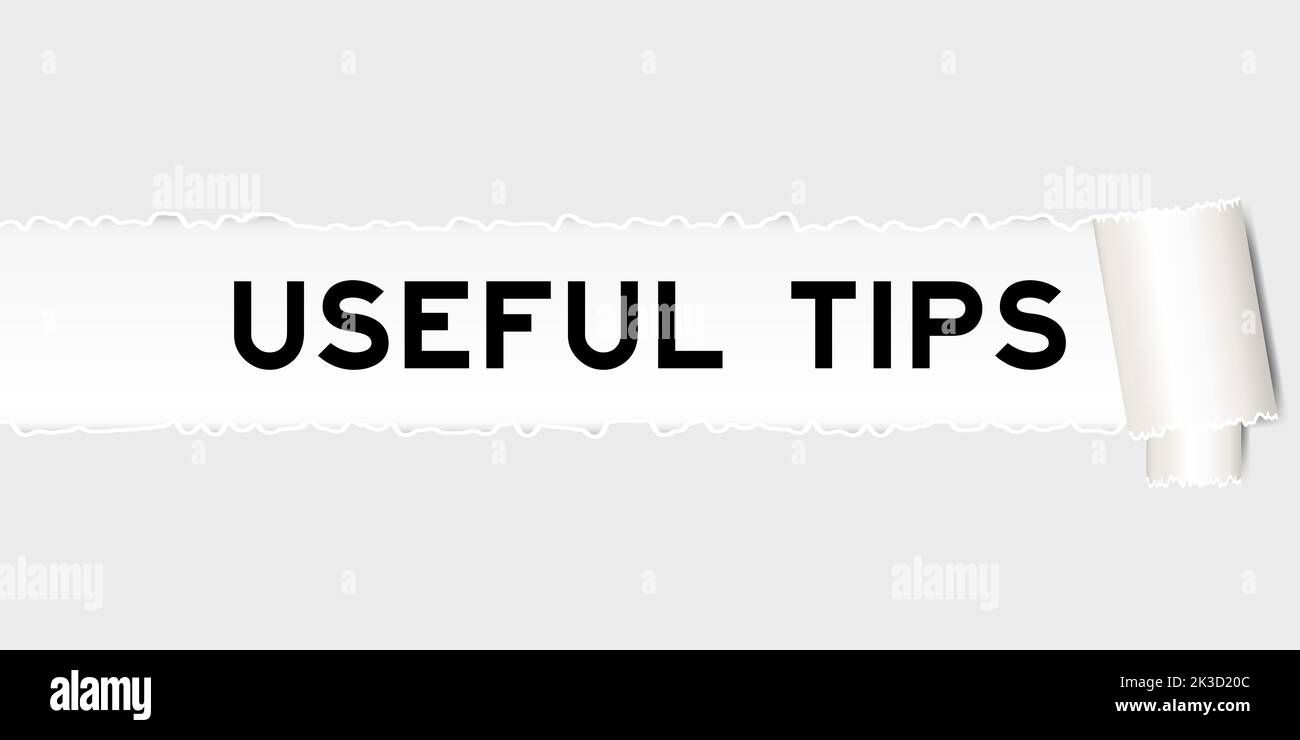 Ripped gray paper background that have word useful tips under torn part ...