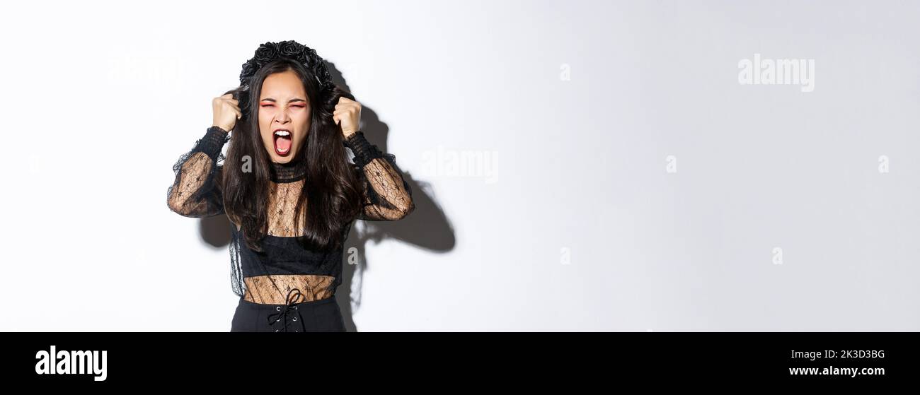 Image of angry distressed asian woman screaming and ripping hair of ...