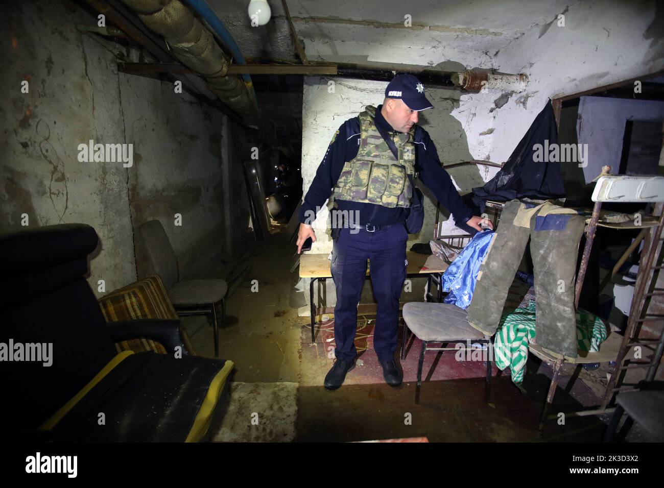 LYPTSI, UKRAINE - SEPTEMBER 24, 2022 - A police officer examines the ...