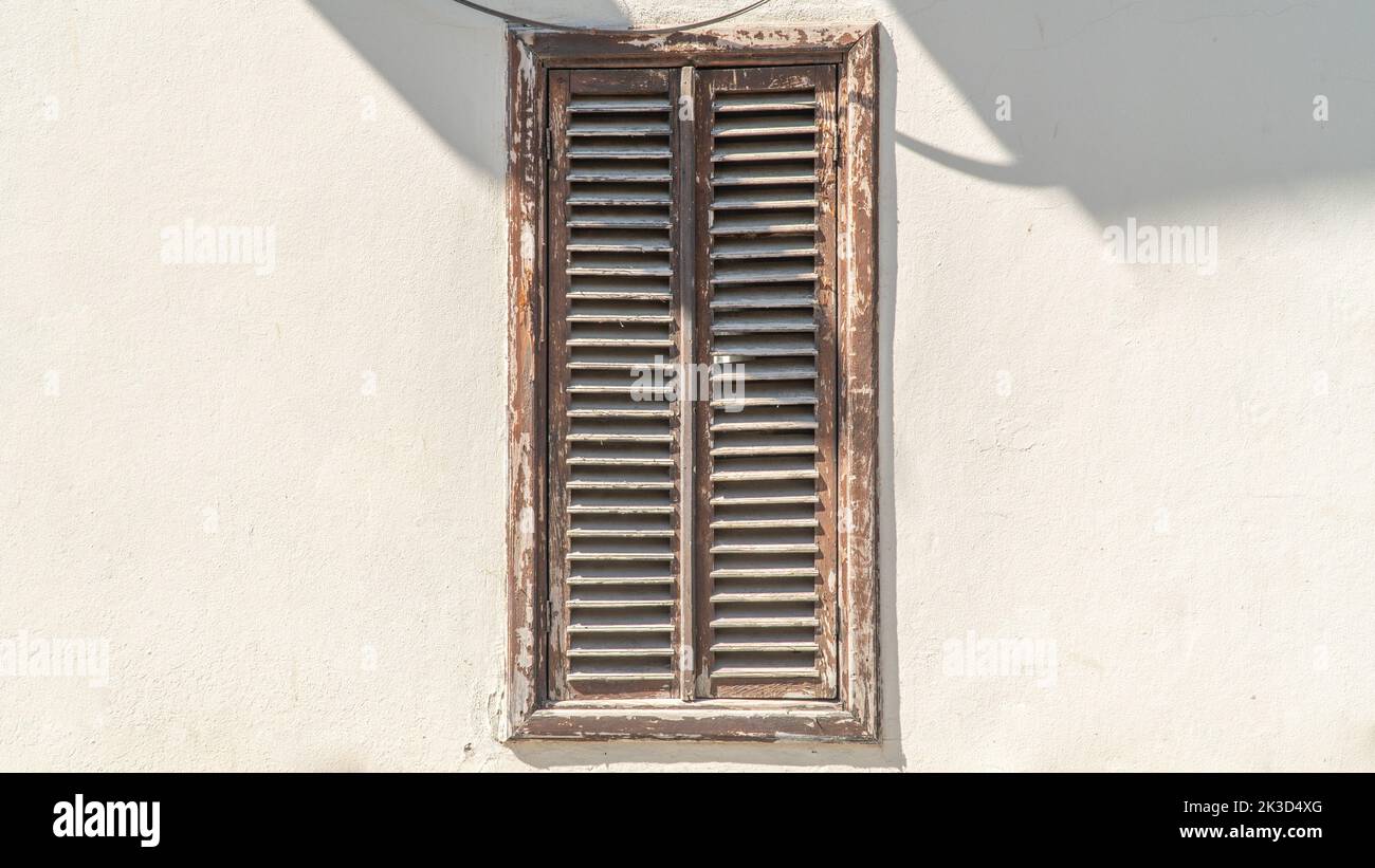 Closed wooden window shutters on a white wall, background Stock Photo ...