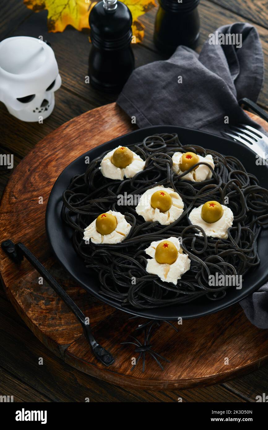 Halloween party Italian black pasta decorated horror olives like eyes ...