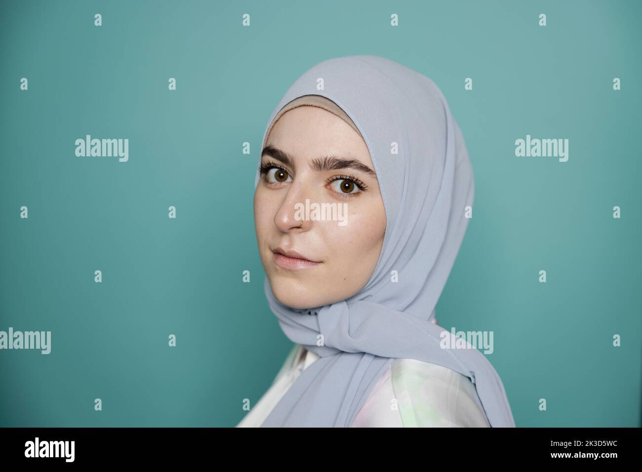 Confident young muslim woman in purple hijab hi-res stock photography ...