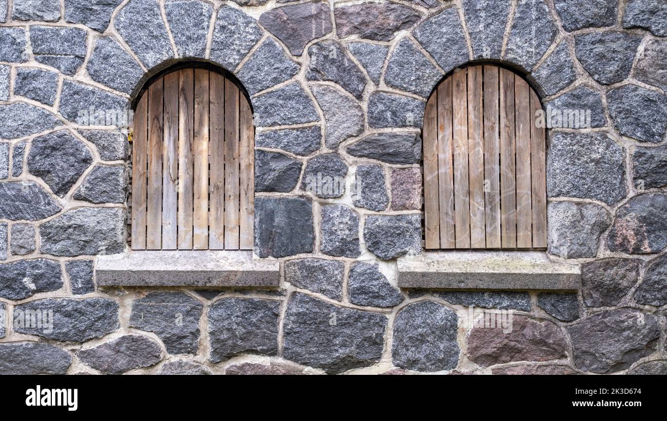 Old, boarded up window in the ruined wall of an old manor house in ...