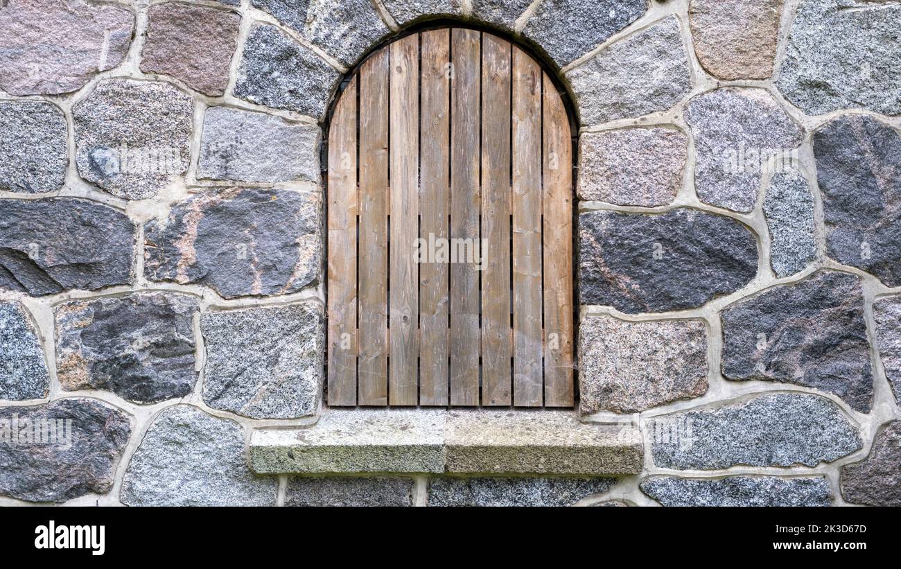 Old, boarded up window in the ruined wall of an old manor house in ...