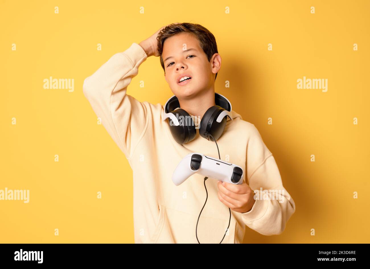 A young child having fun playing video games standing isolated over ...