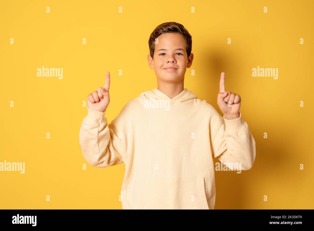 Portrait of cheerful boy with good idea - isolated over yellow ...
