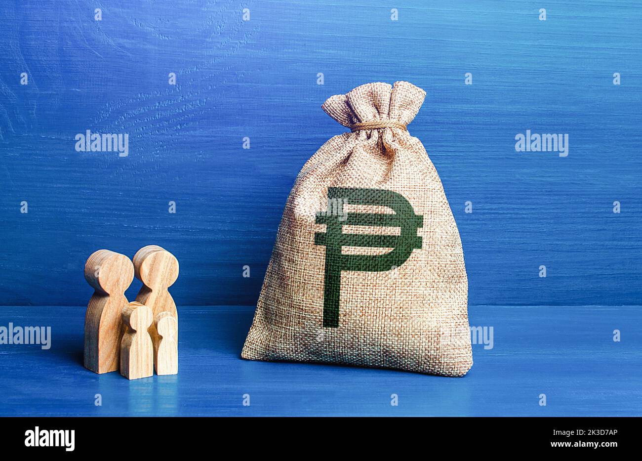 Family figurines and philippine peso money bag. Family budget. Income ...