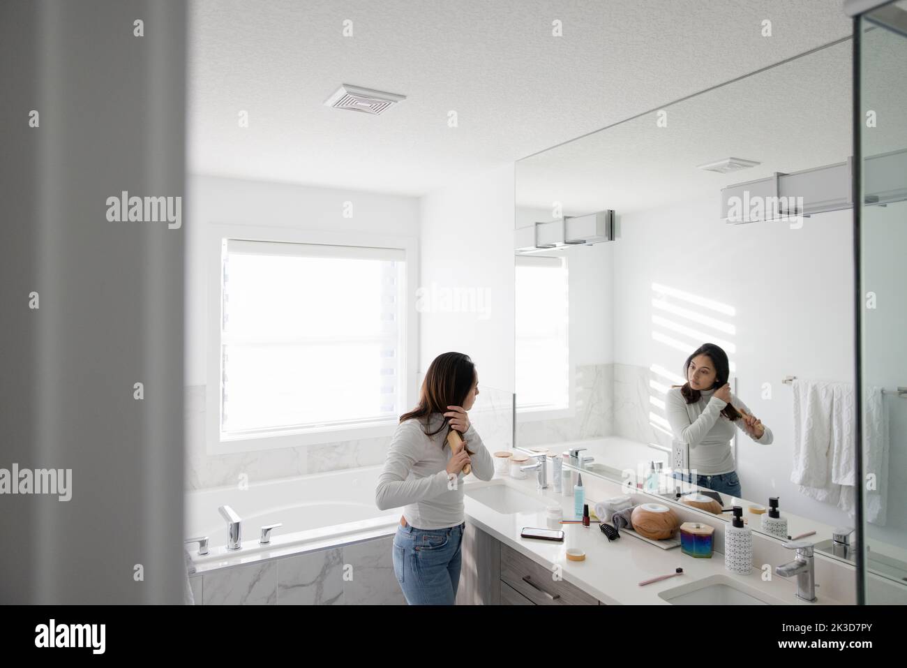 Woman brushing hair mirror hi-res stock photography and images - Alamy