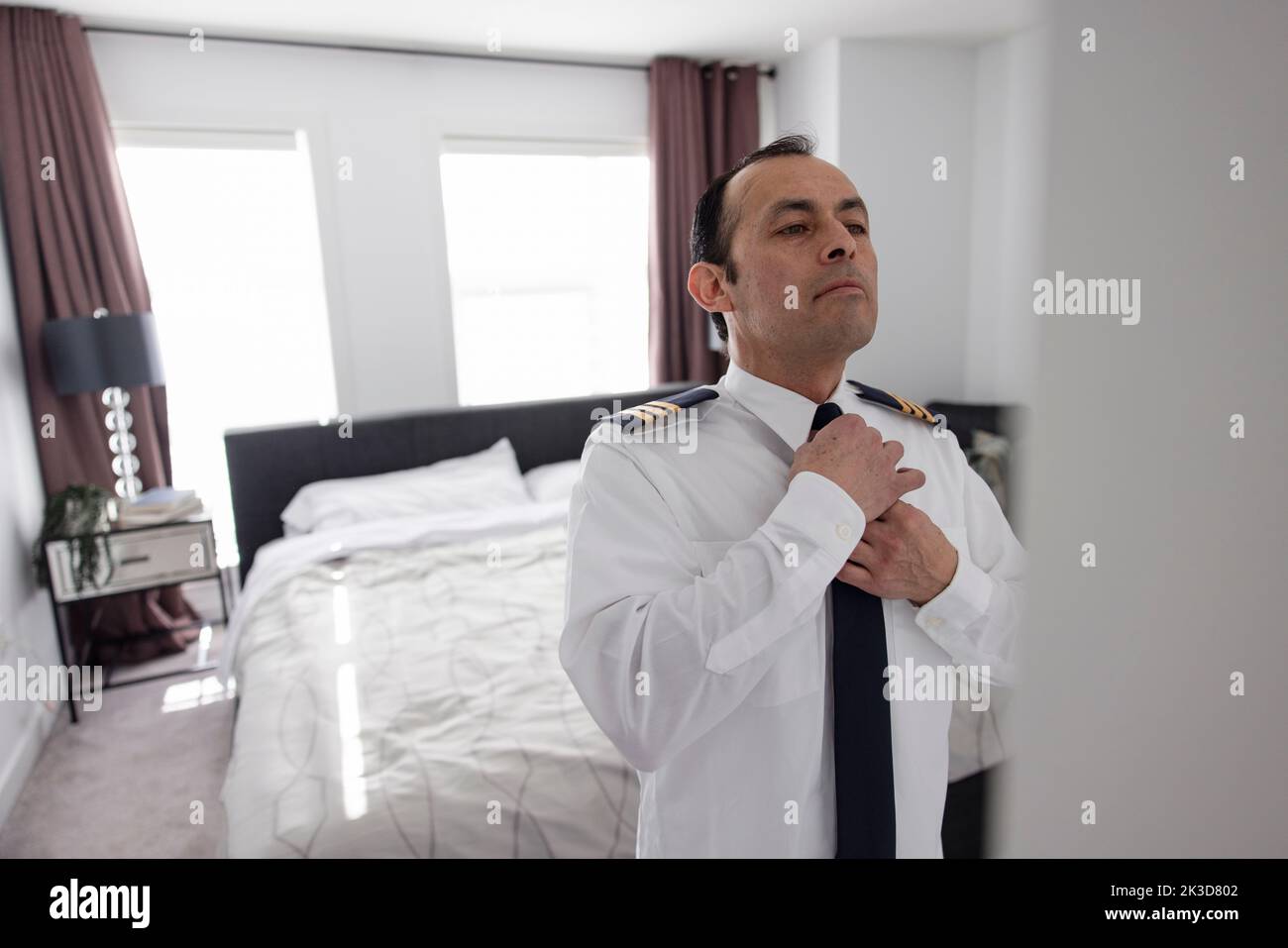 Putting on uniform in morning bedroom hi-res stock photography and ...