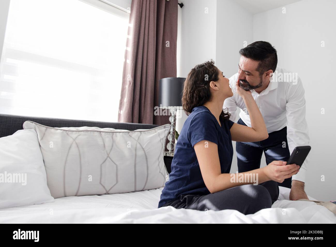Mobile phone couple bed hi-res stock photography and images - Alamy