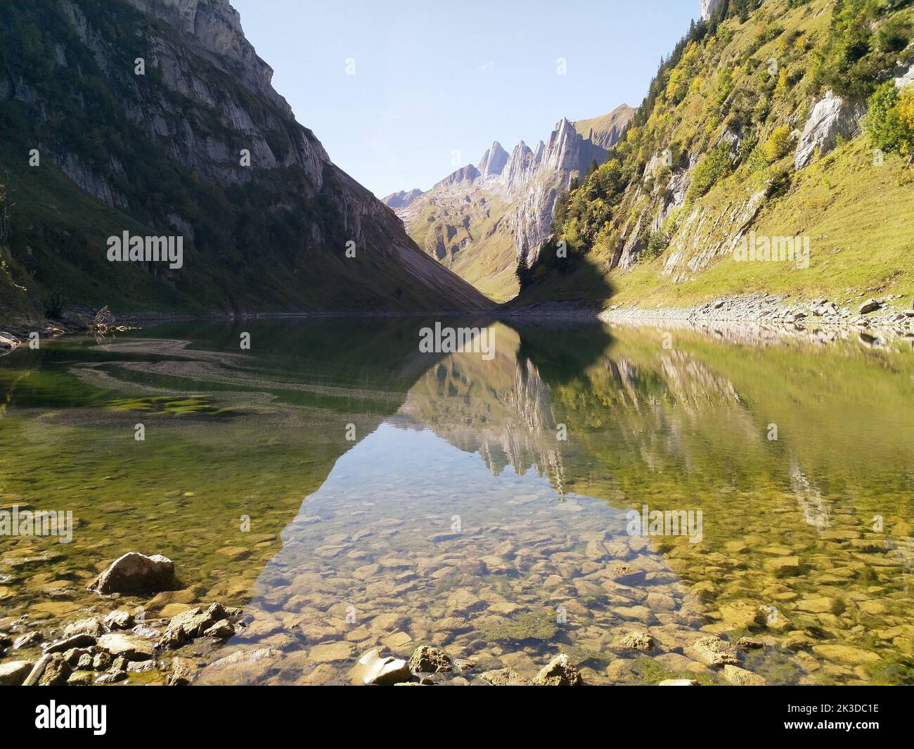 Shallow lake with stoes surrounded with mountains in Switzerland Stock ...