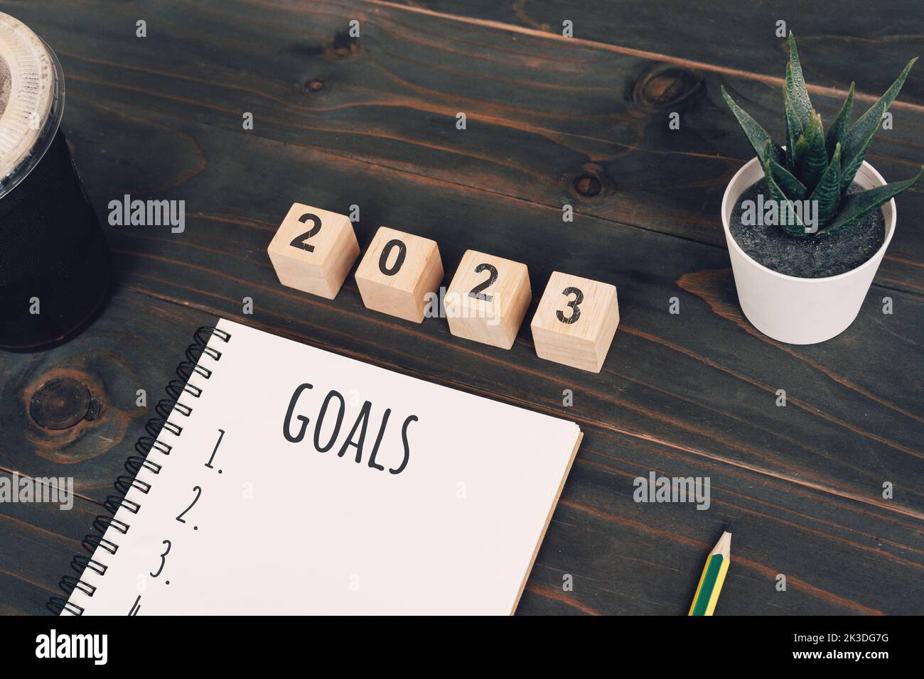2023 goals text on notepad with coffee cup and pen on wooden desk Stock ...