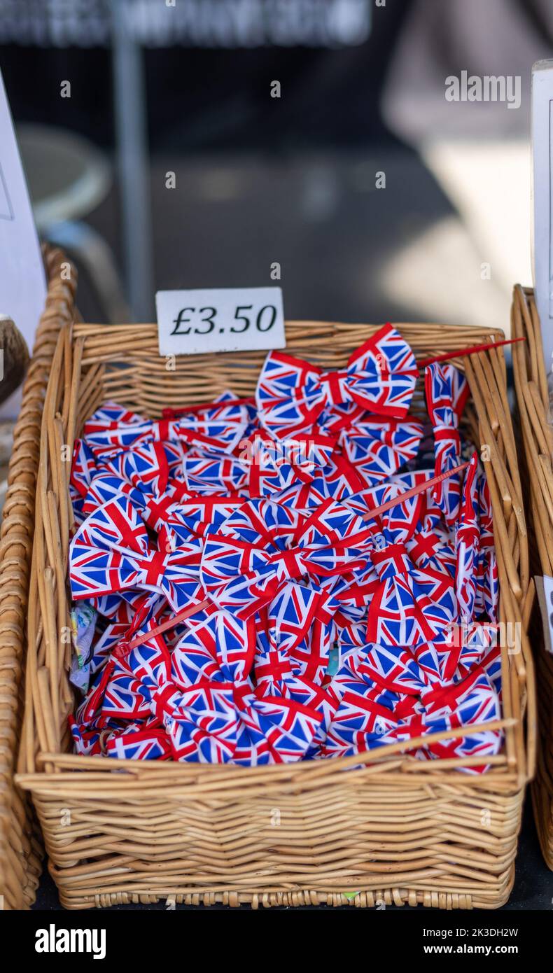 A vertical shot of a box of plastic union jack bow ties for souvenirs ...