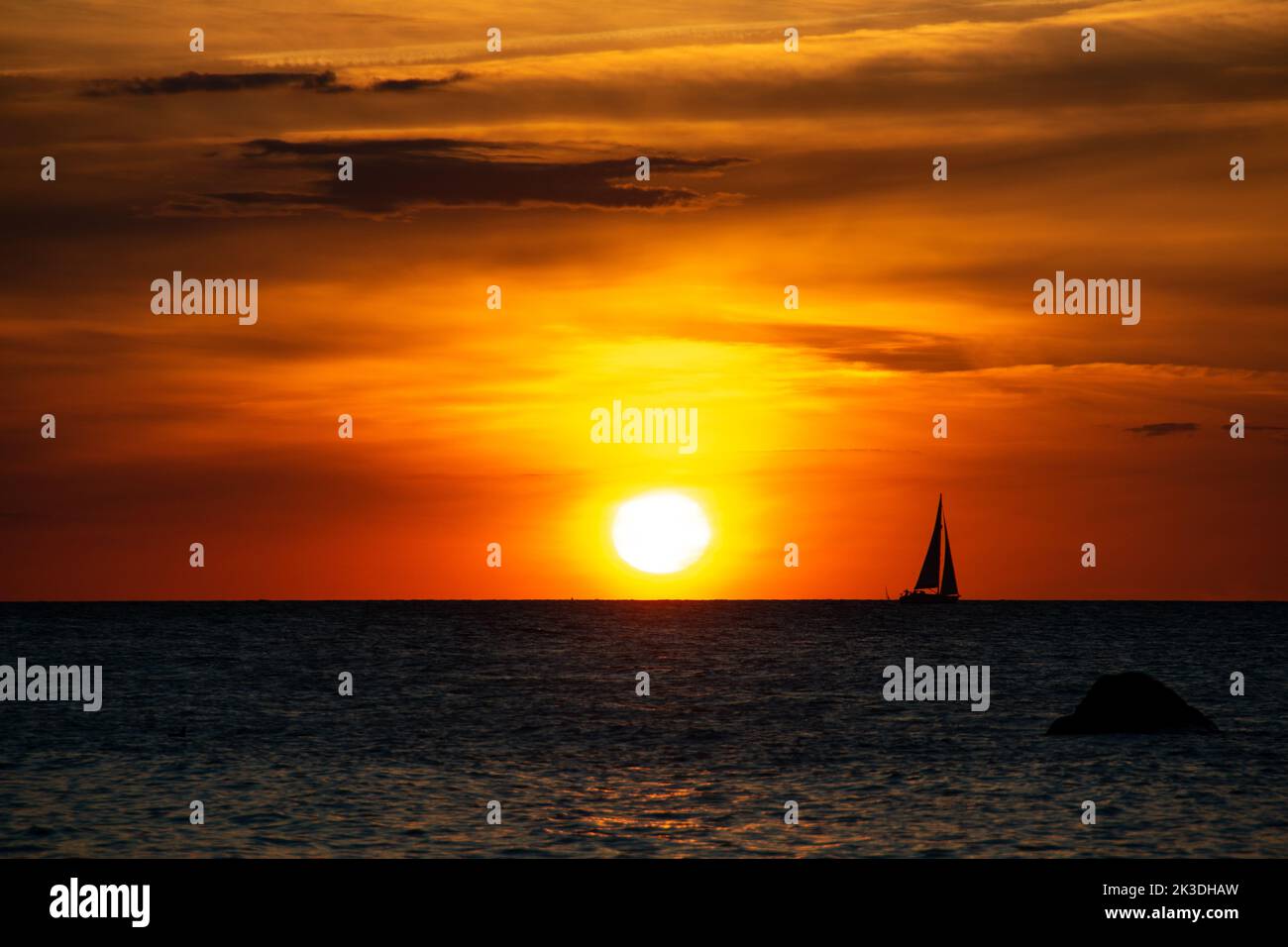Beautiful orange sunset over the sea, a ship on the horizon Stock Photo ...
