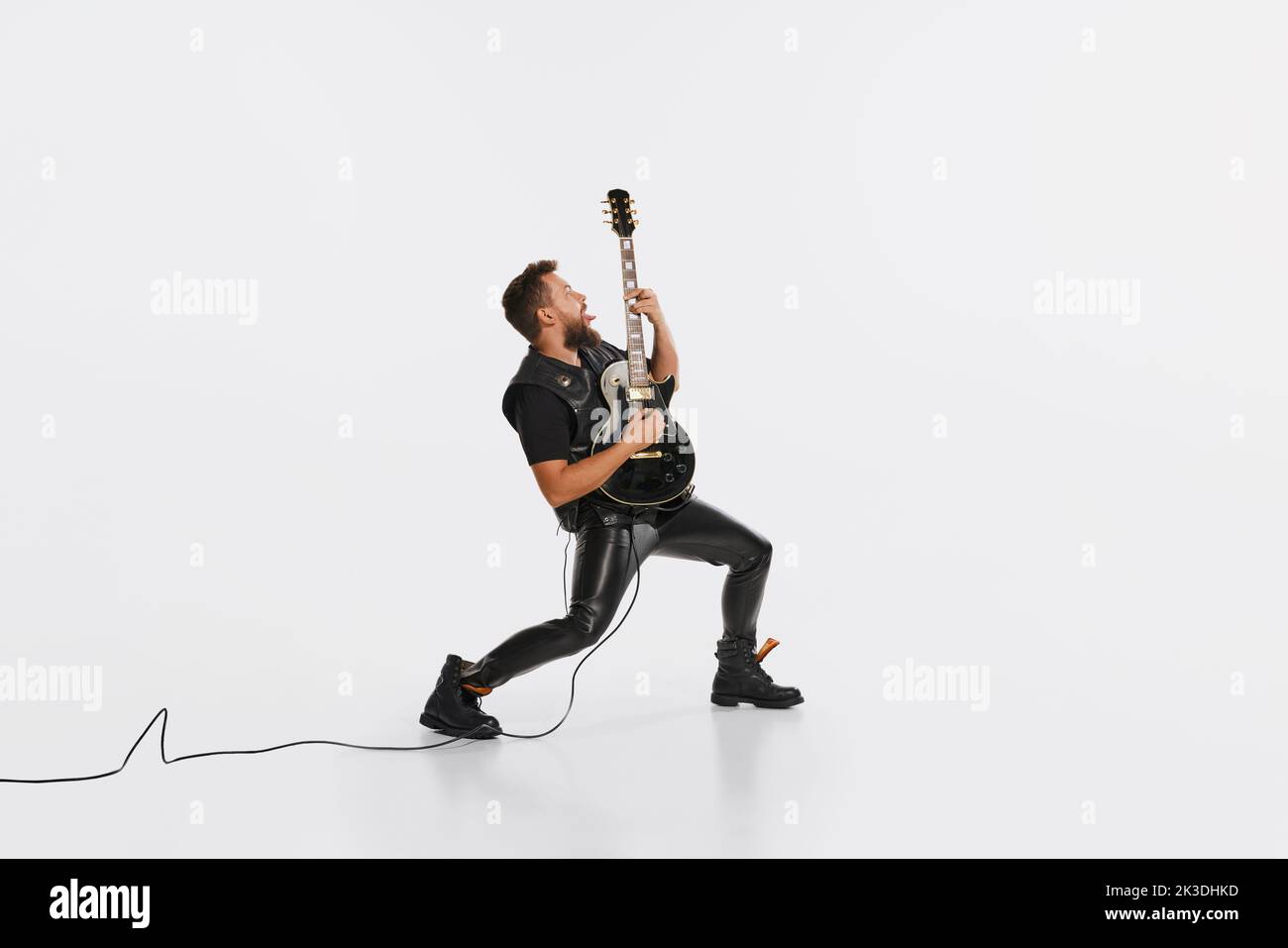 Stylish musician wearing retro style clothes playing guitar like ...