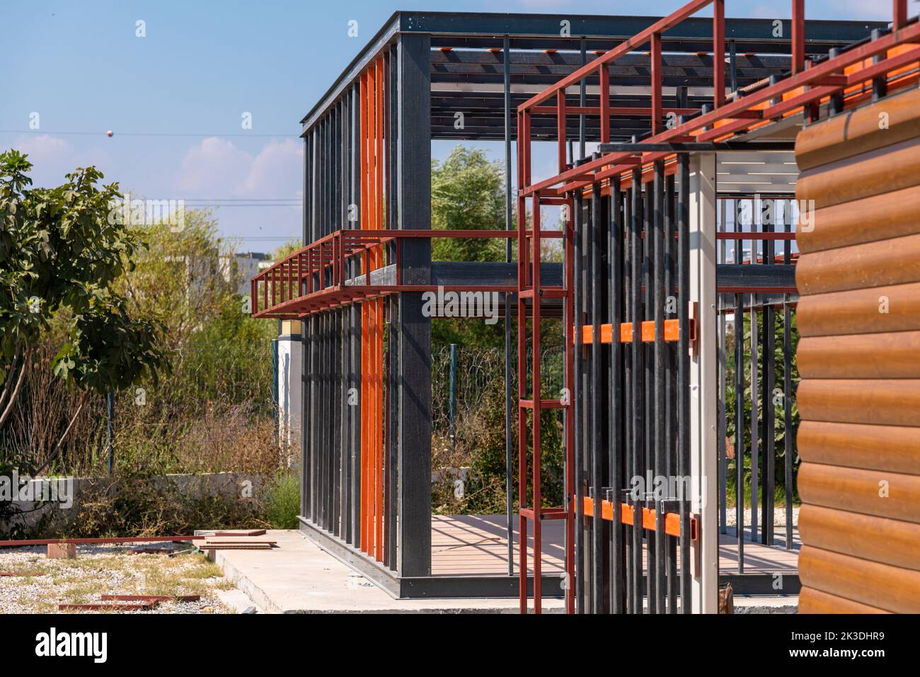 Metal frame of newly built building. Construction of a new tiny house ...