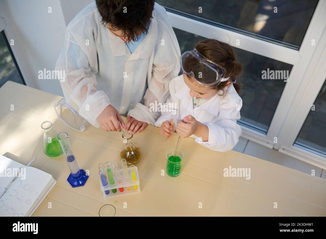 Top view of smart kids pupils, elemantary students, chemists scientists ...