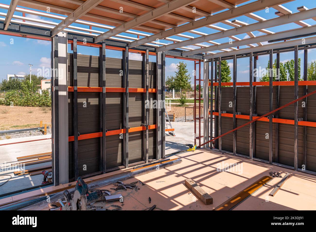 Metal frame of newly built building. Construction of a new tiny house ...