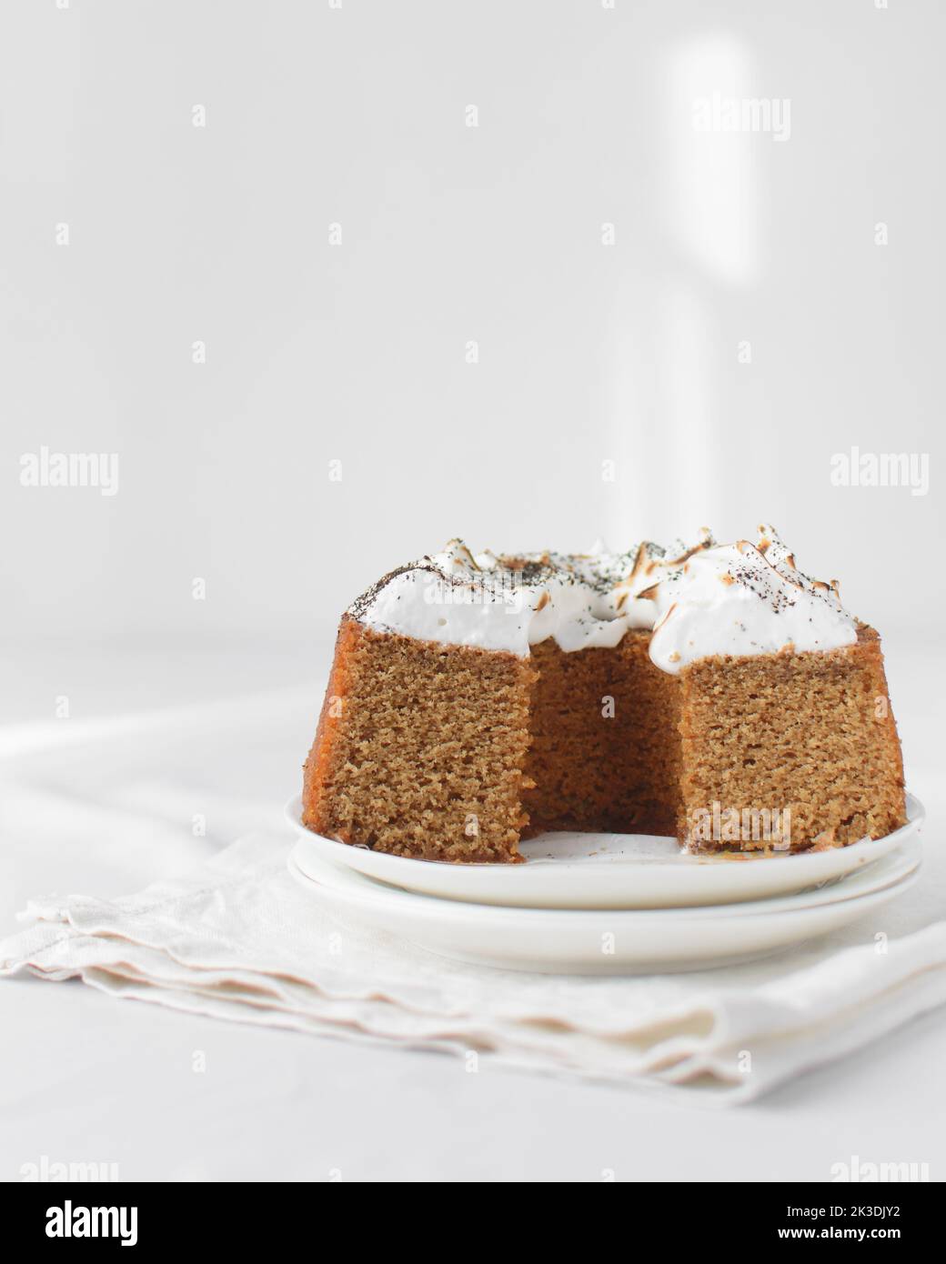Sliced homemade bundt cake with a toasted meringue topping Stock Photo ...