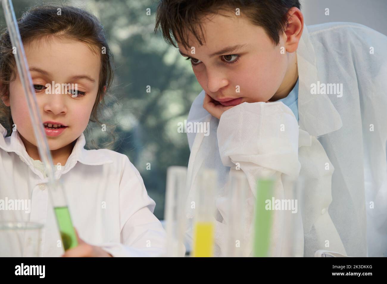 Adorable Caucasian children, boy and girl, smart pupils in science ...