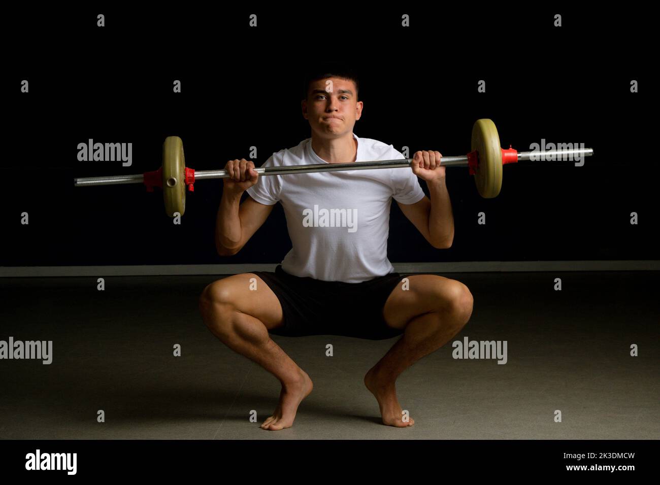 Teenage boy lifting weights hi-res stock photography and images - Alamy