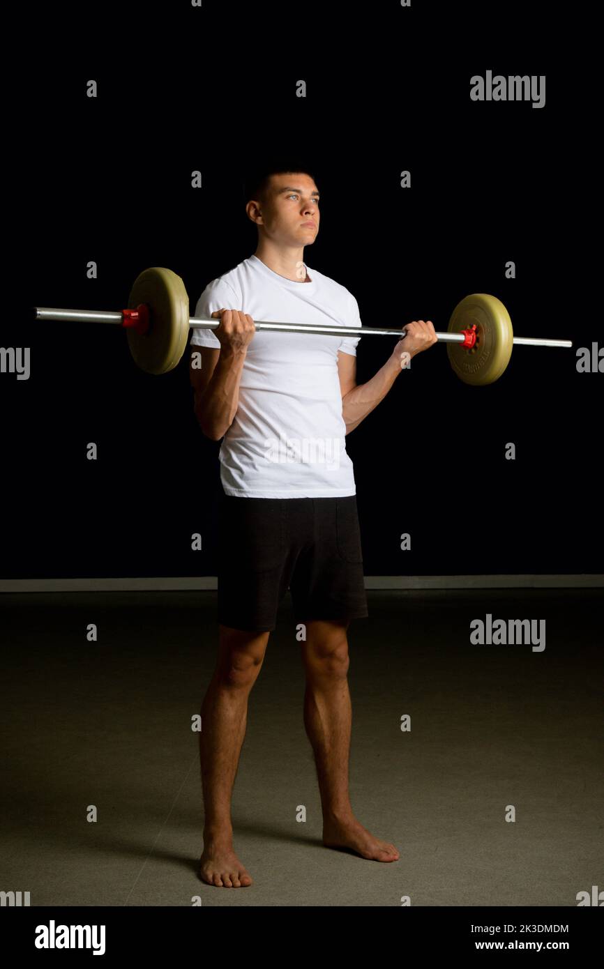 19 year old teenage boy excercising his biceps with a barbell Stock ...