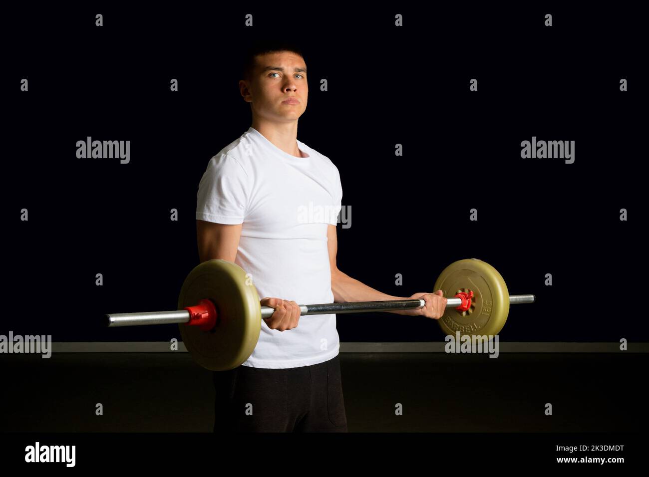 19 year old teenage boy excercising his biceps with a barbell Stock ...
