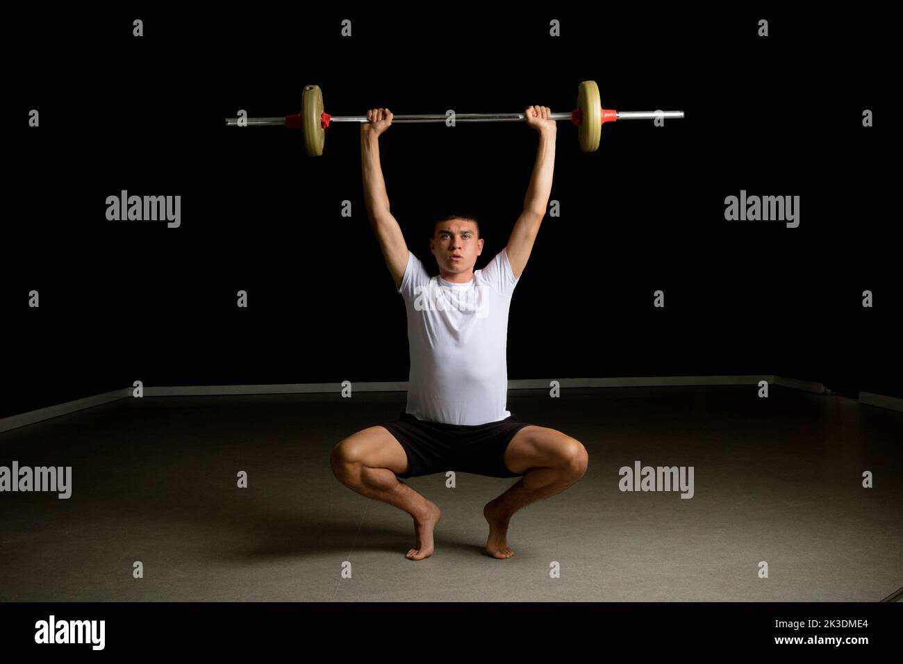 19 year old teenage boy lifting a barbell above his head Stock Photo ...