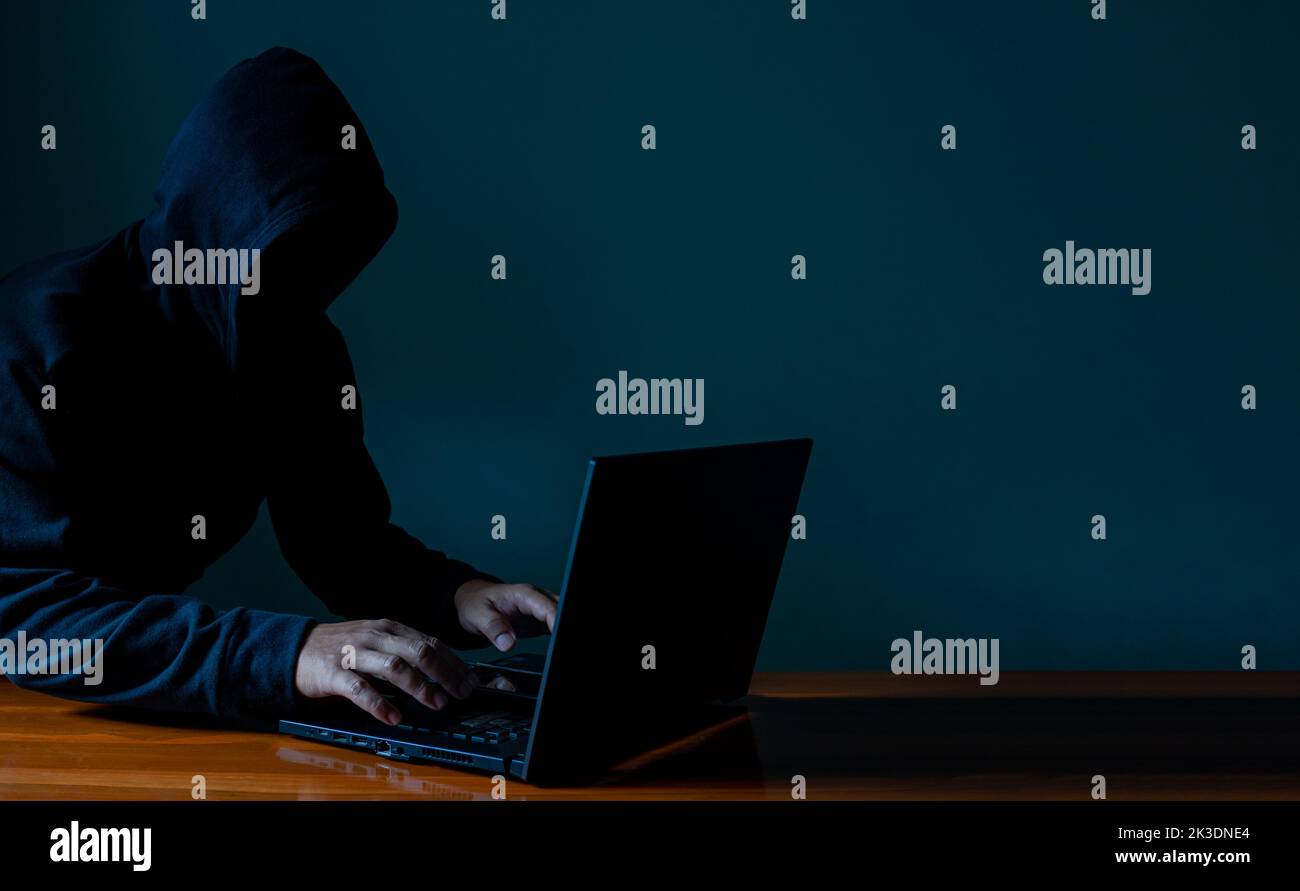 Hackers work on laptops in the dark. The concept of information ...