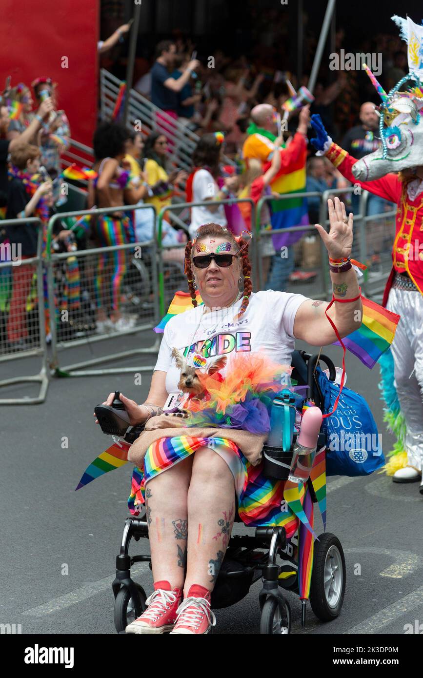 A vertical shot of a disabled woman in the wheelchair with the rainbow ...