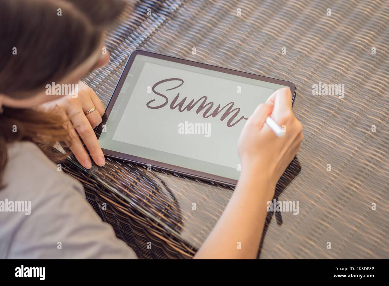 Calligrapher Young Woman writes phrase on digital tablet. Inscribing ...