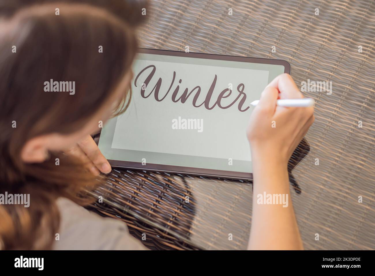 Calligrapher Young Woman writes phrase on digital tablet. Inscribing ...