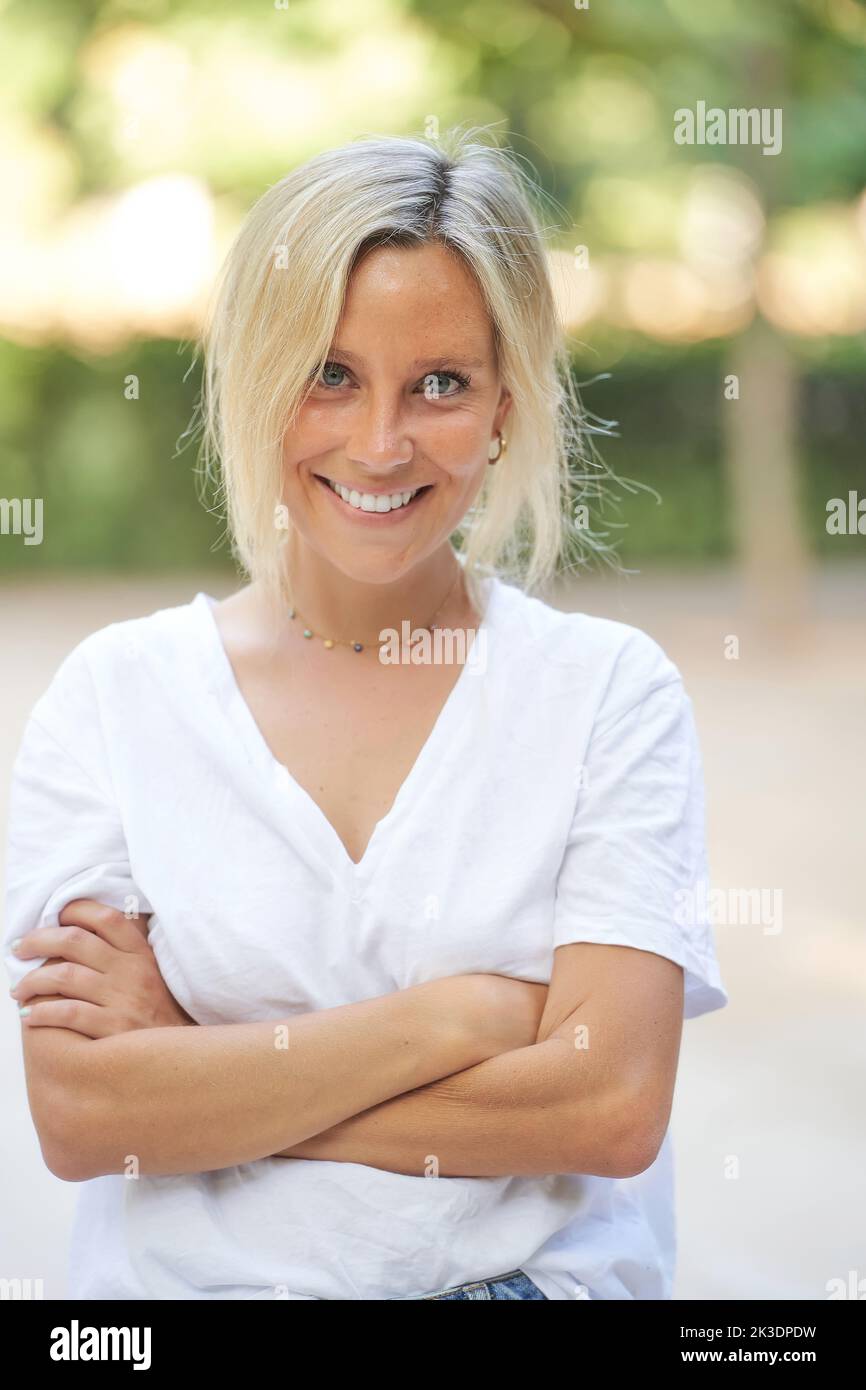 Looking at camera standing smiling arms crossed hi-res stock ...