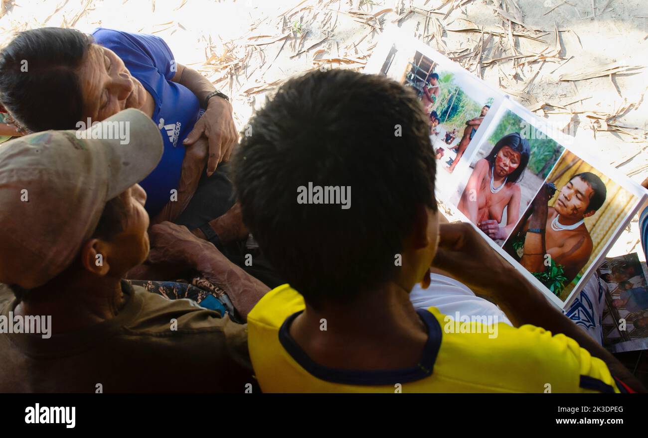 Colombia, Piraparana, Tukano indians looking at a photo book with ...