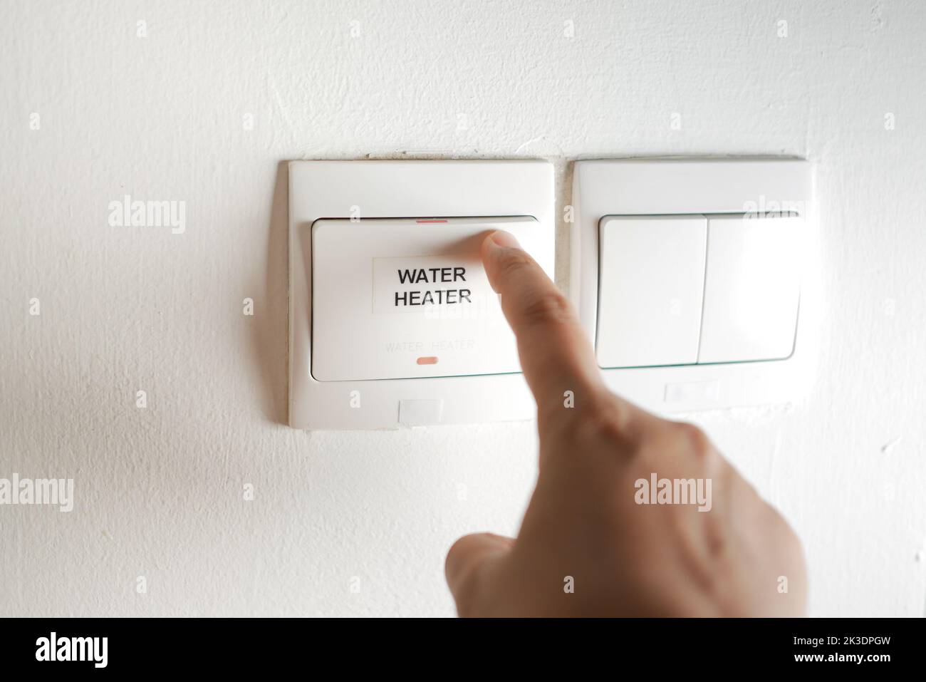 A finger turning on lighting switch Stock Photo - Alamy