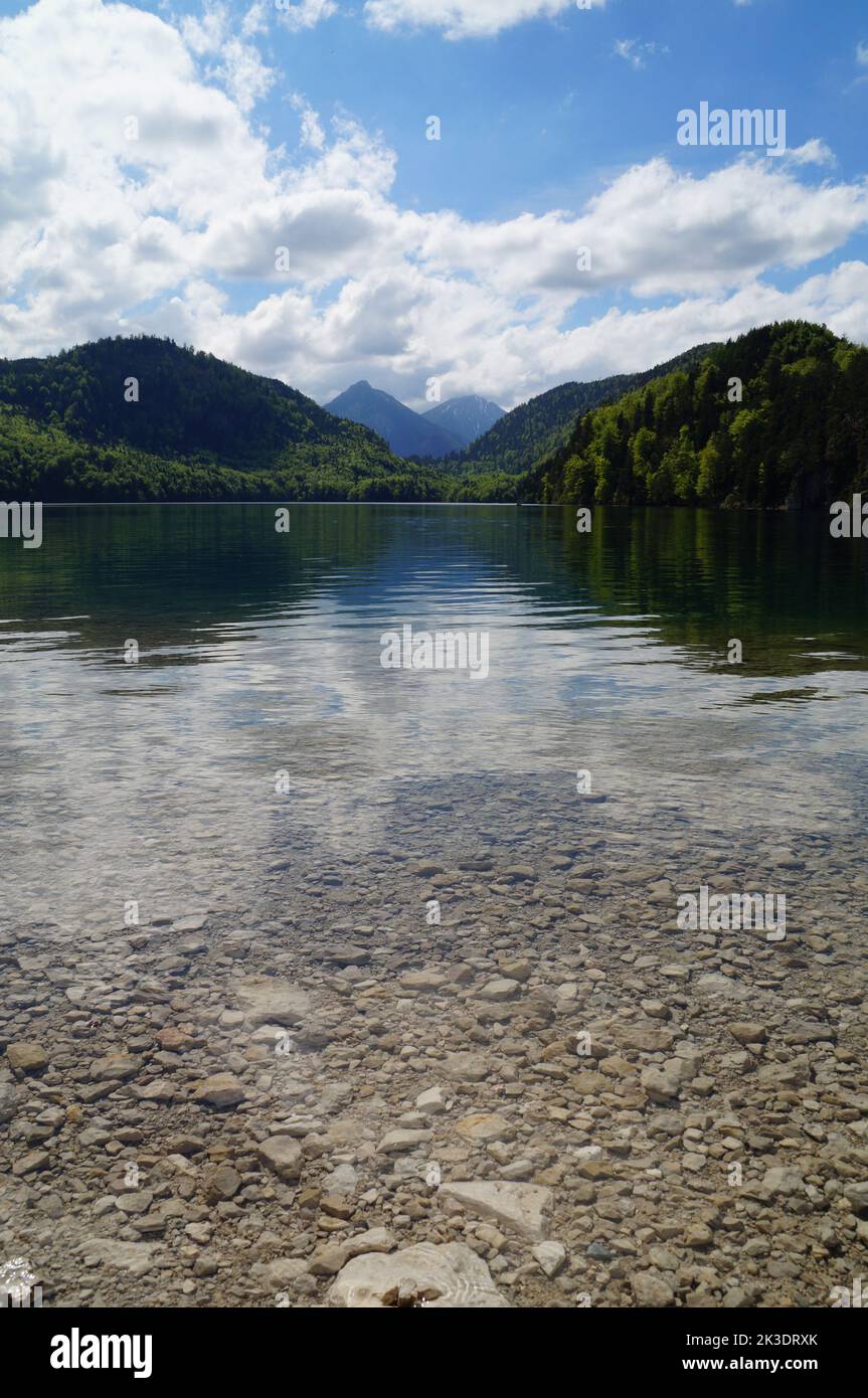 gorgeous emerald-green lake Alpsee in the German Alps in Hohenschwangau ...