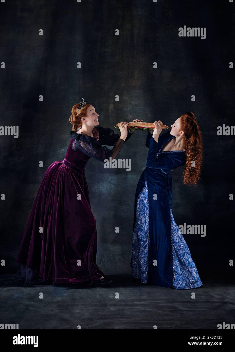 Portrait of two beautiful women in image of queens fighting for giant ...